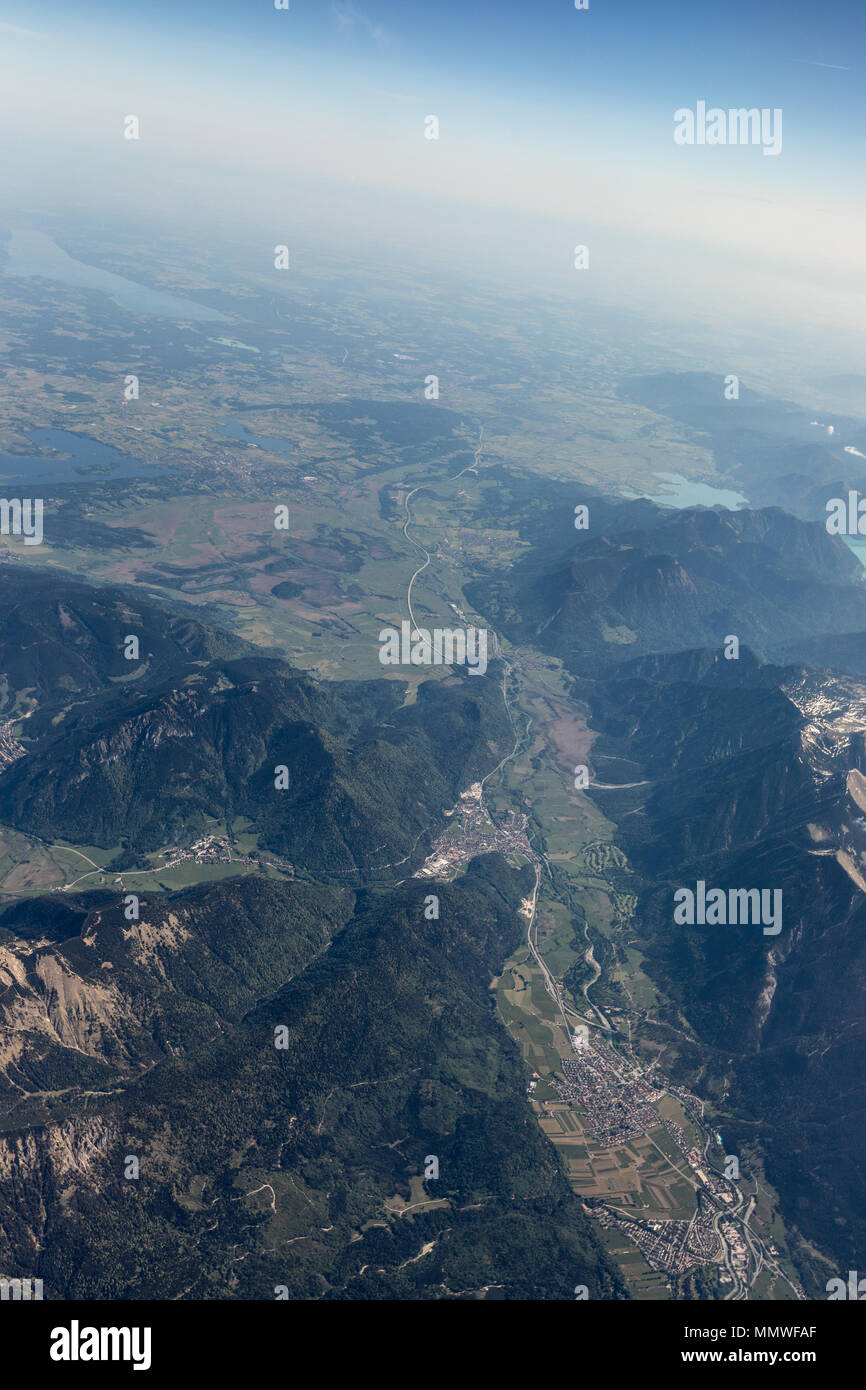 View from the airplane to the sky above the Alps mountains. Blue sky ...