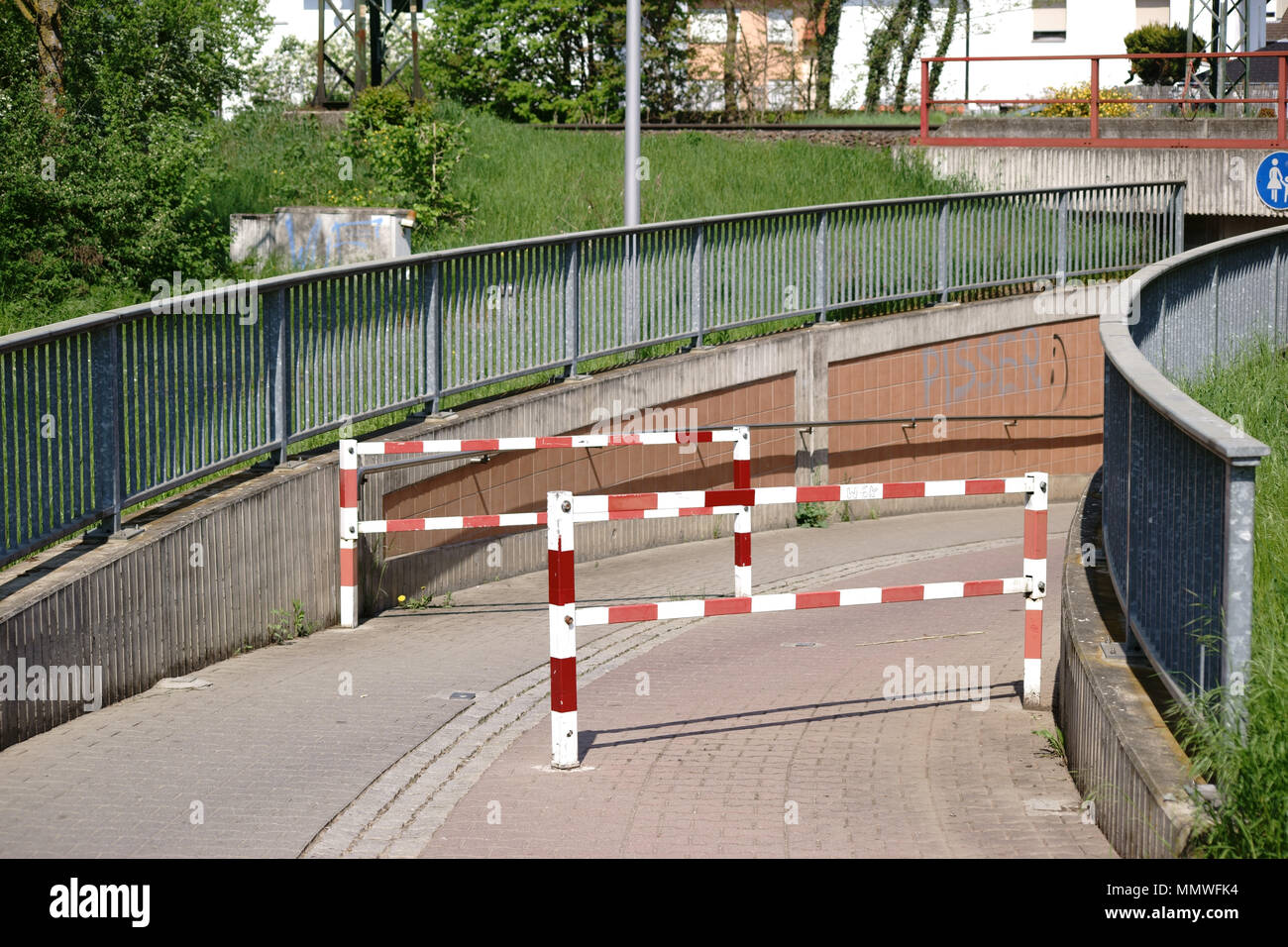 A curve leads to a bridge underpass or a tunnel under a rail track ...
