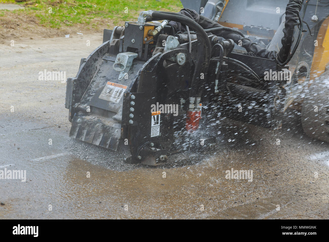 Road construction machine breaks up Asphalt milling machine working on ...