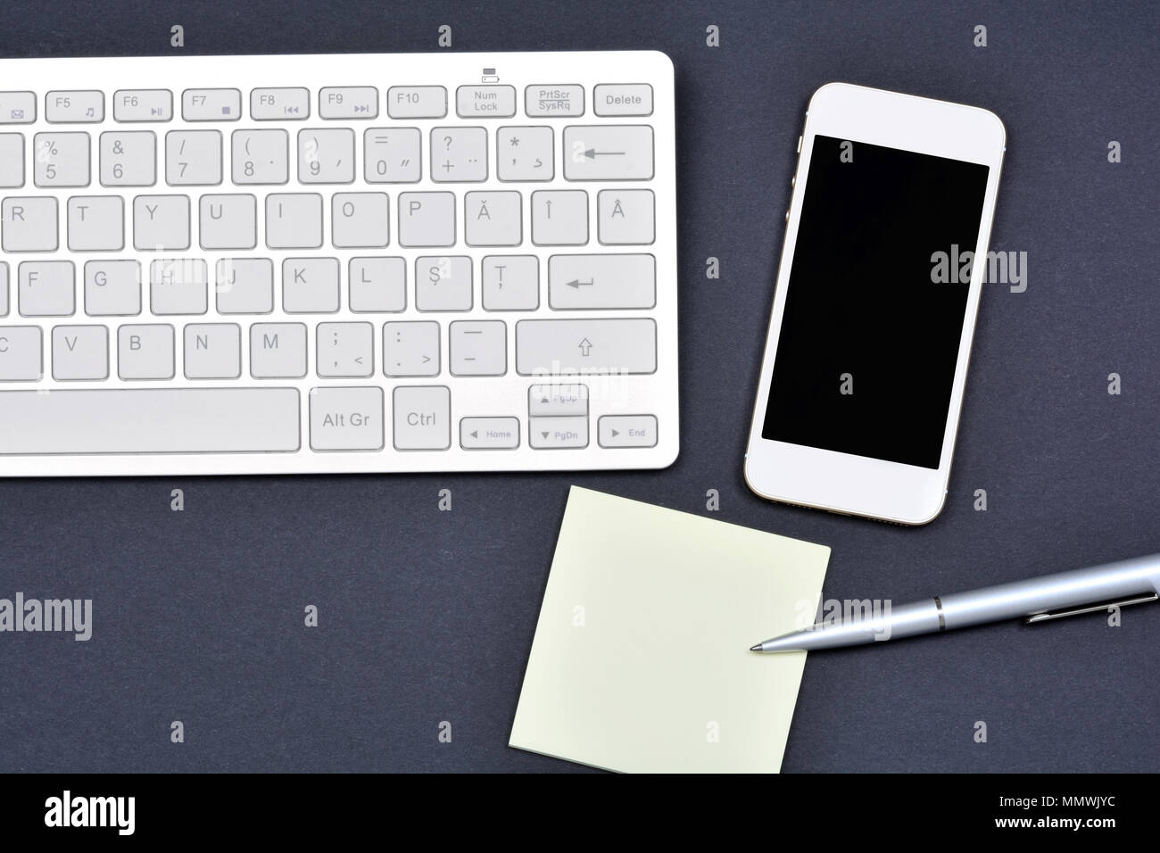Office desk with keyboard computer with telephone and notes closeup ...