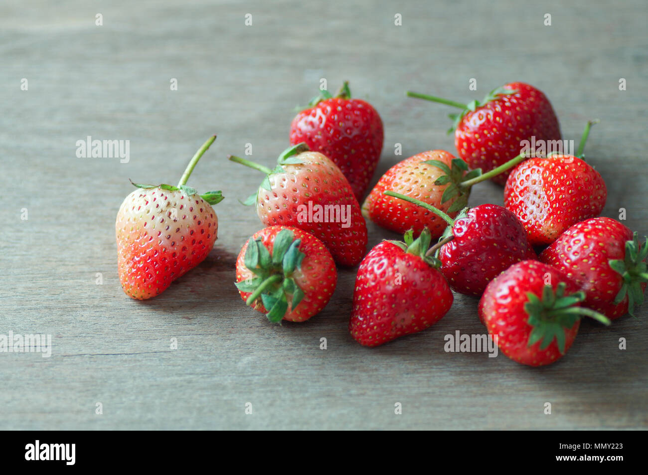 Fresh strawberries on wooden table with low key scene Stock Photo - Alamy