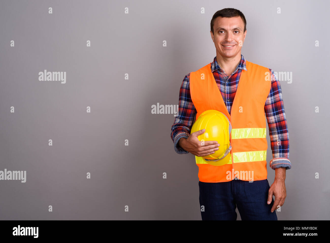 Man construction worker against gray background Stock Photo - Alamy