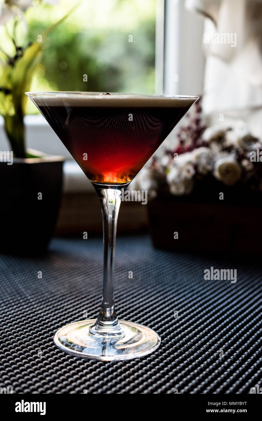 Black Cocktail in front of the window. Beverage Concept Stock Photo - Alamy