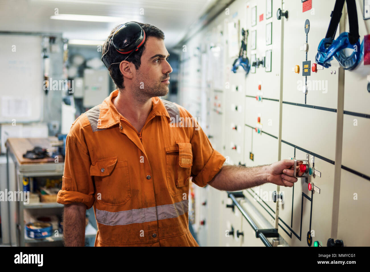 Marine engineer officer starts or stops main engine of ship in engine ...