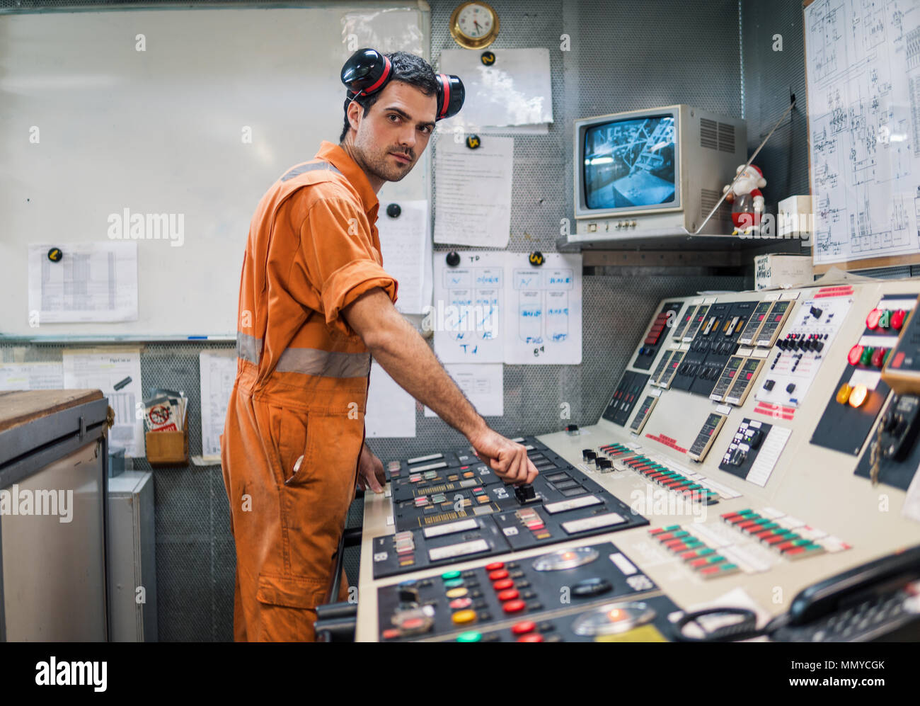 Marine engineer officer starts or stops main engine of ship in engine ...