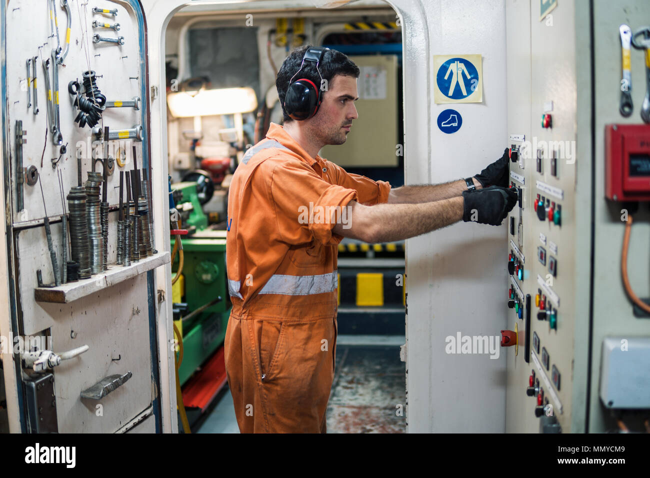 Marine engineer officer controlling vessel engines and propulsion in ...