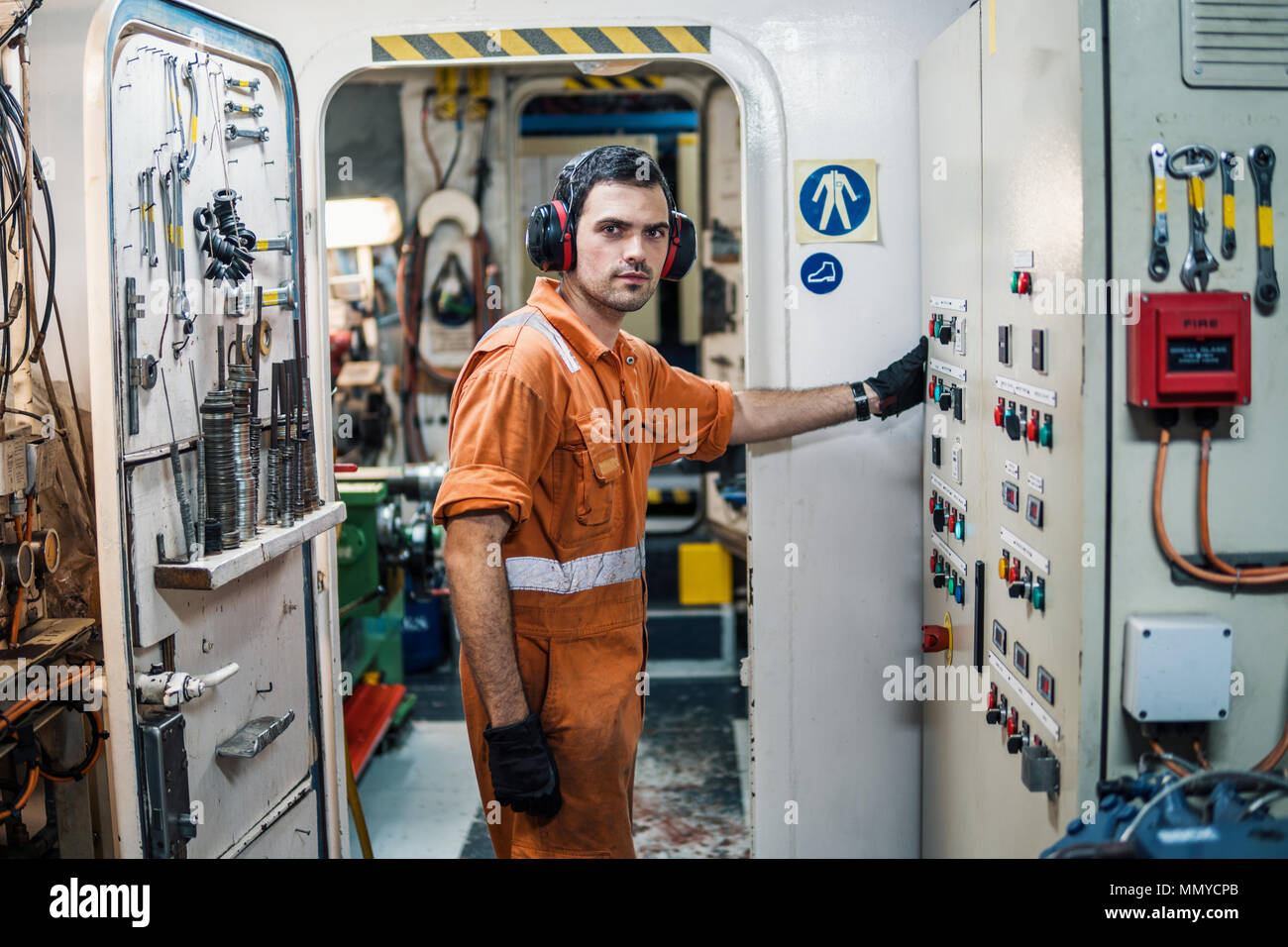 Marine engineer officer controlling vessel engines and propulsion in ...