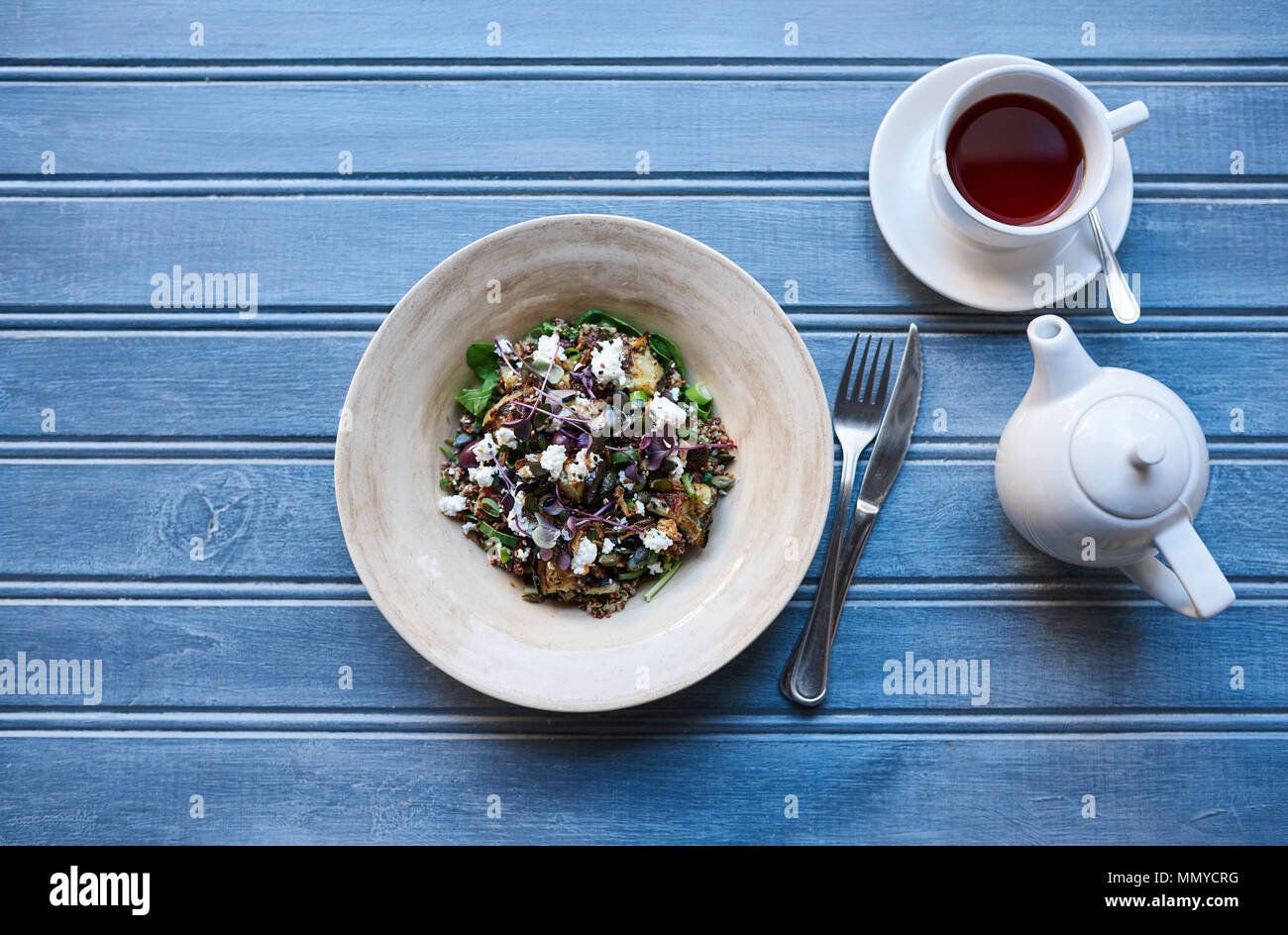 Healthy mixed salad with tea on a rustic blue table Stock Photo - Alamy