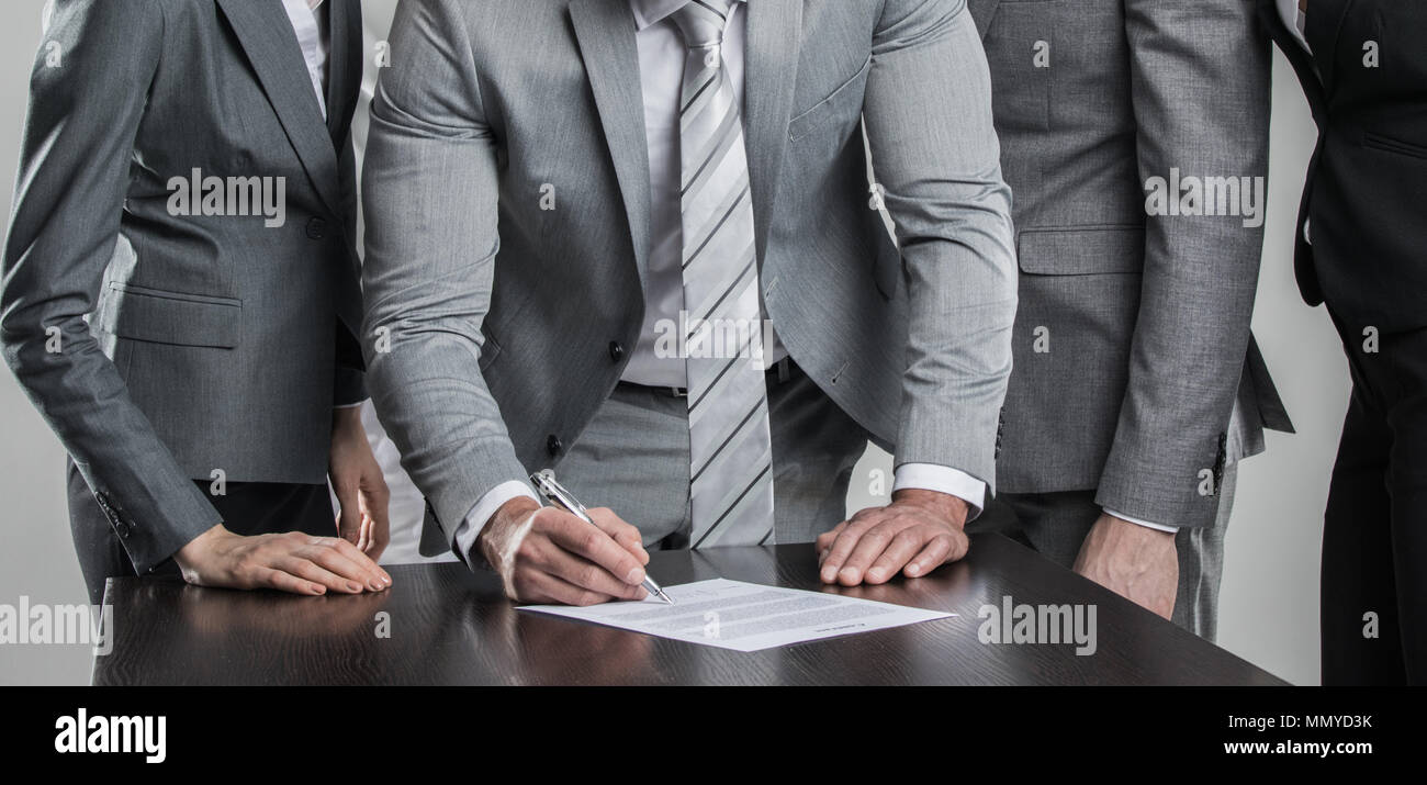 Group of business people sign a contract finishing deal Stock Photo - Alamy