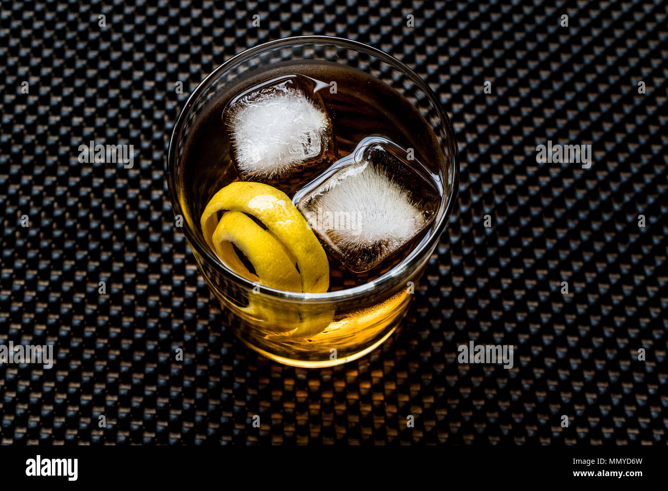 Highball cocktail with lemon peel and ice. Beverage Concept Stock Photo ...