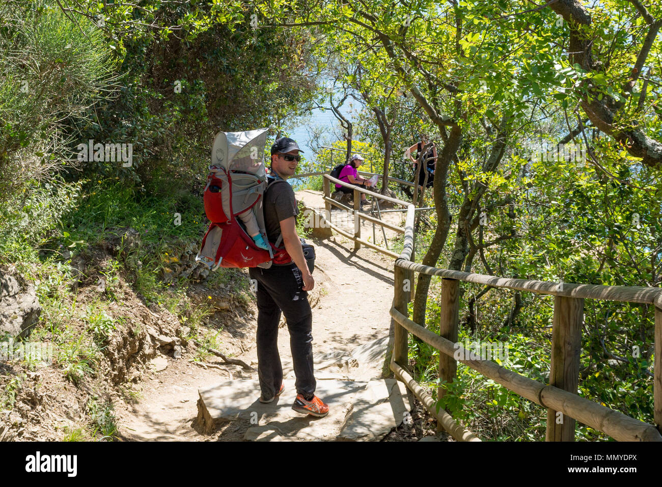 Active father with his child in backpack hiking Stock Photo - Alamy