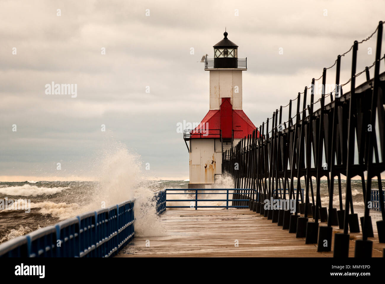 A small lighthouse out on a pier in St. Joeseph Michigan during stromy ...