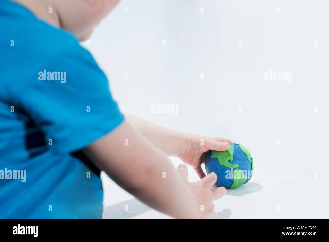 Small Earth model with human hands. Abstract composition of peace Stock ...