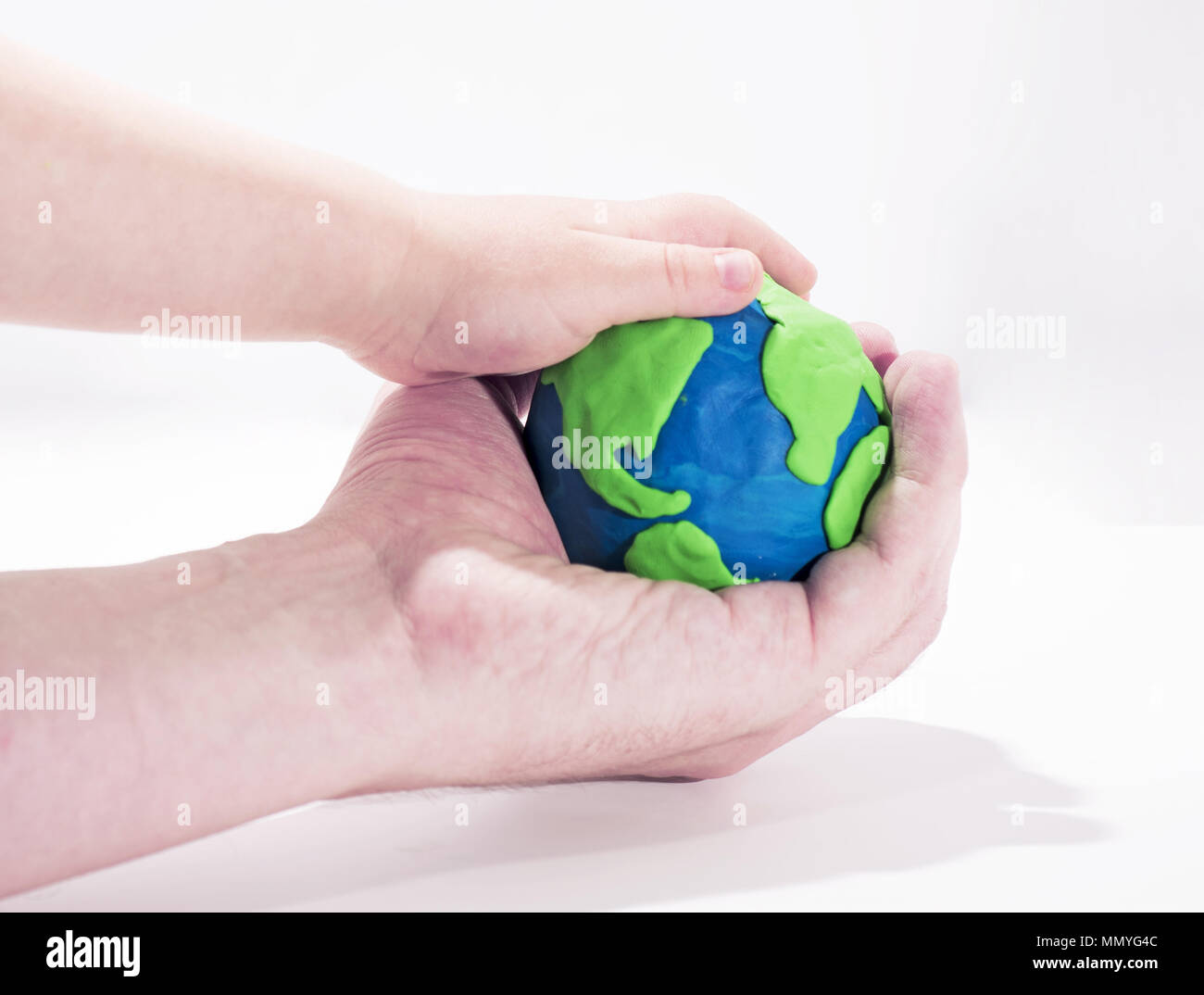 Small Earth model with human hands. Abstract composition of peace Stock ...