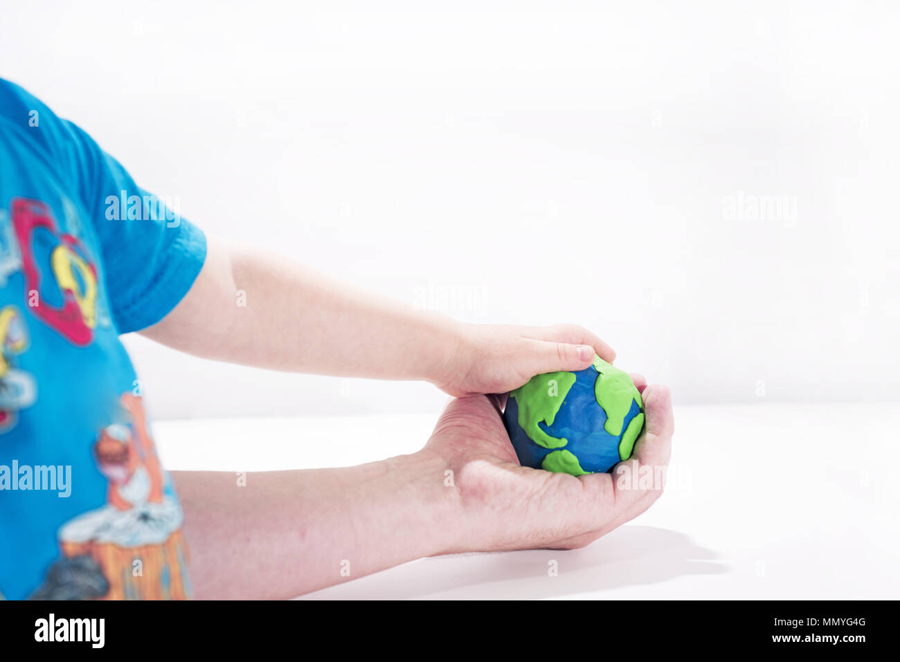 Small Earth model with human hands. Abstract composition of peace Stock ...