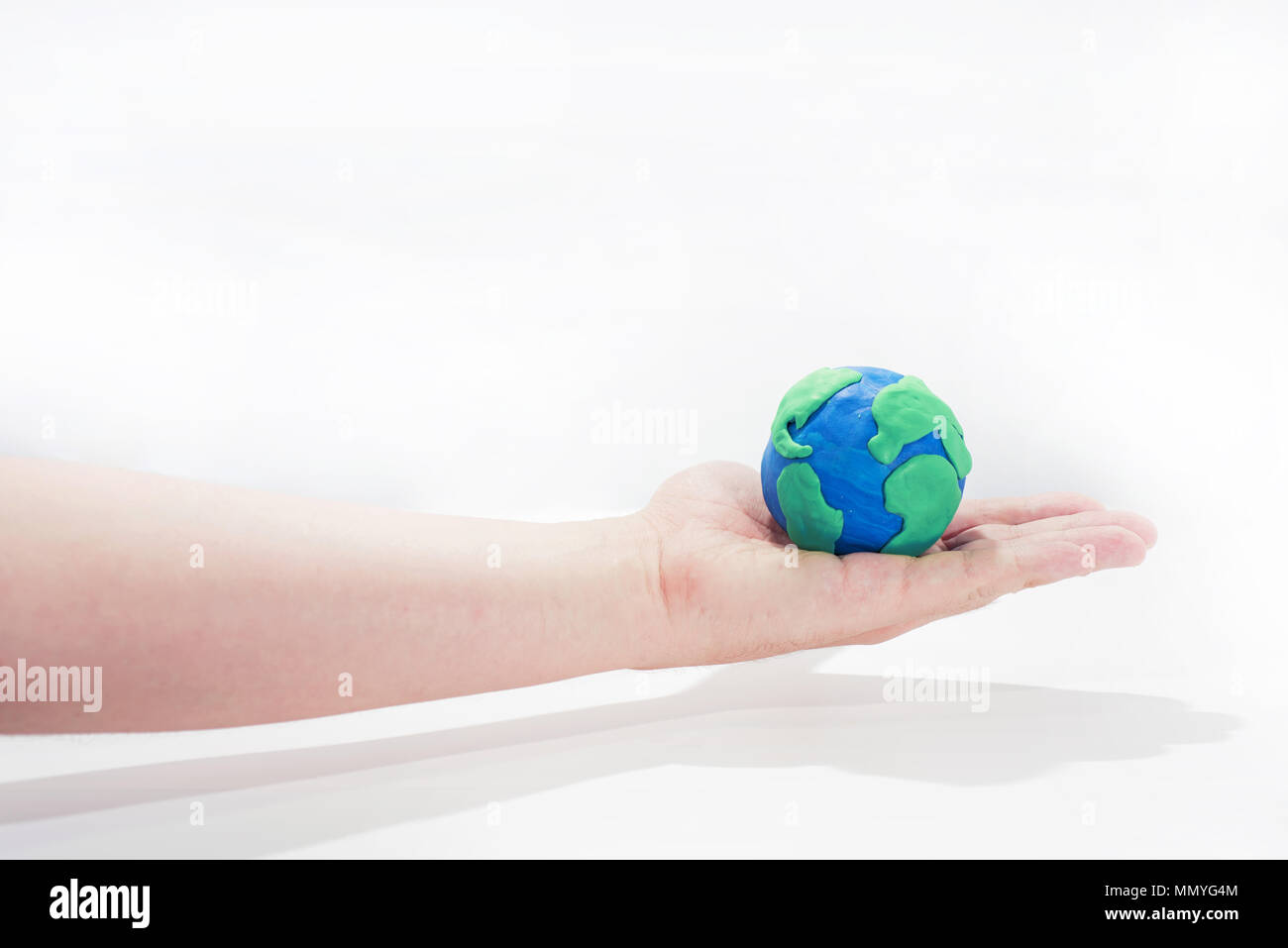 Small Earth model with human hands. Abstract composition of peace Stock ...