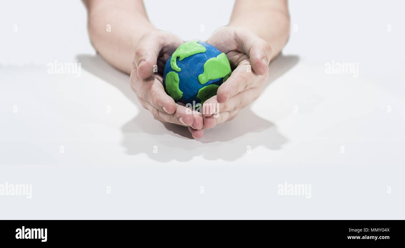 Small Earth model with human hands. Abstract composition of peace Stock ...