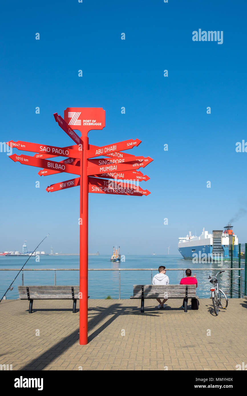 People watching a vessel sail out of the lock 'Pierre Vandammesluis' in ...