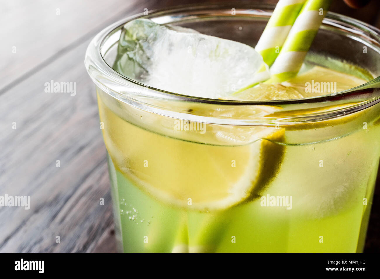 Midori Sour Cocktail with ice and lemon. Beverage Concept Stock Photo ...