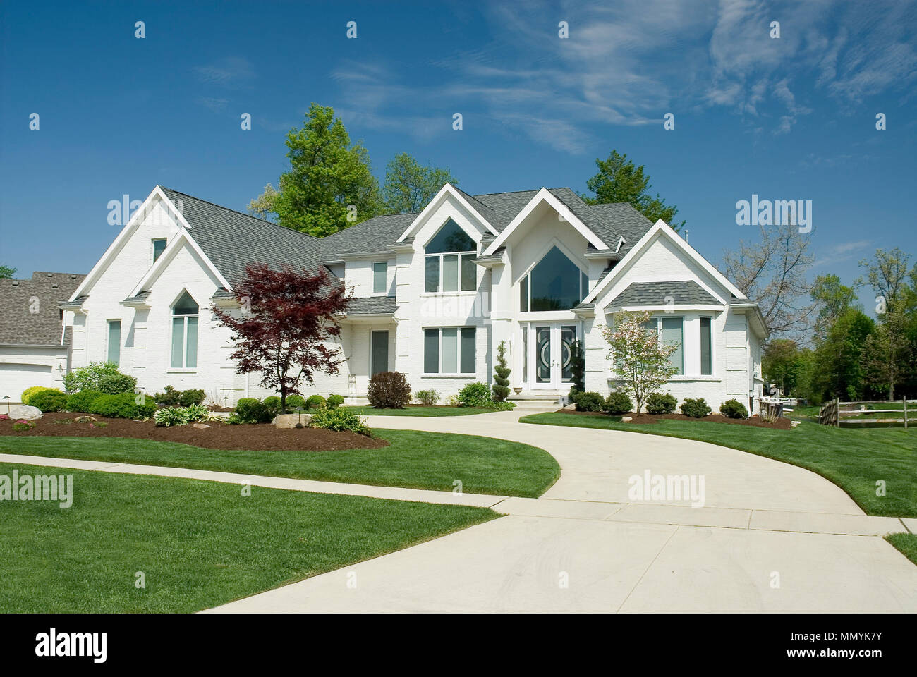 Beautiful white brick home featuring a very modern architectural design ...