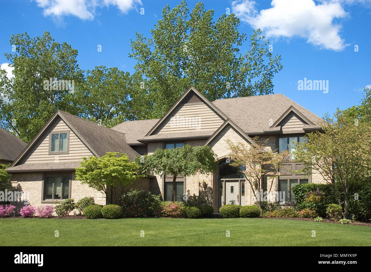 Beautiful brown two-story wood and brick home. Typical new home in the ...