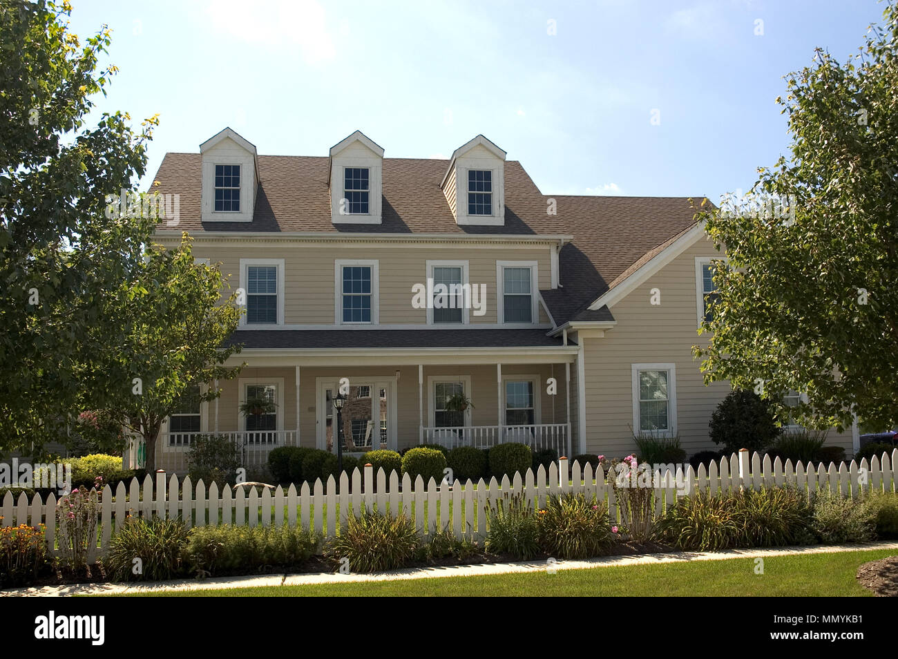 Beautiful colonial style home featuring a traditional white picket ...