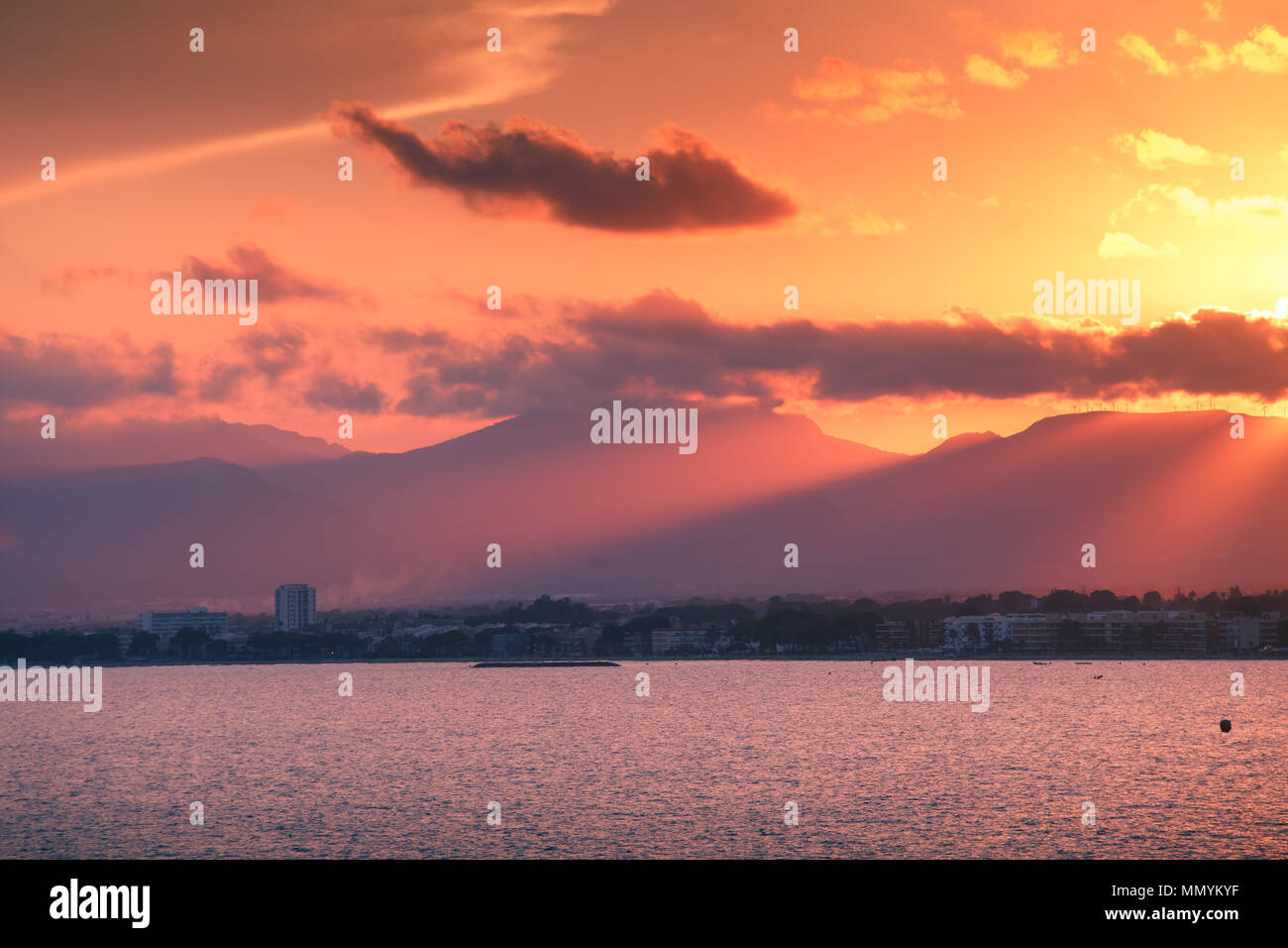 Colorful sunset over spanish coastline. Seascape with sun rays in the ...