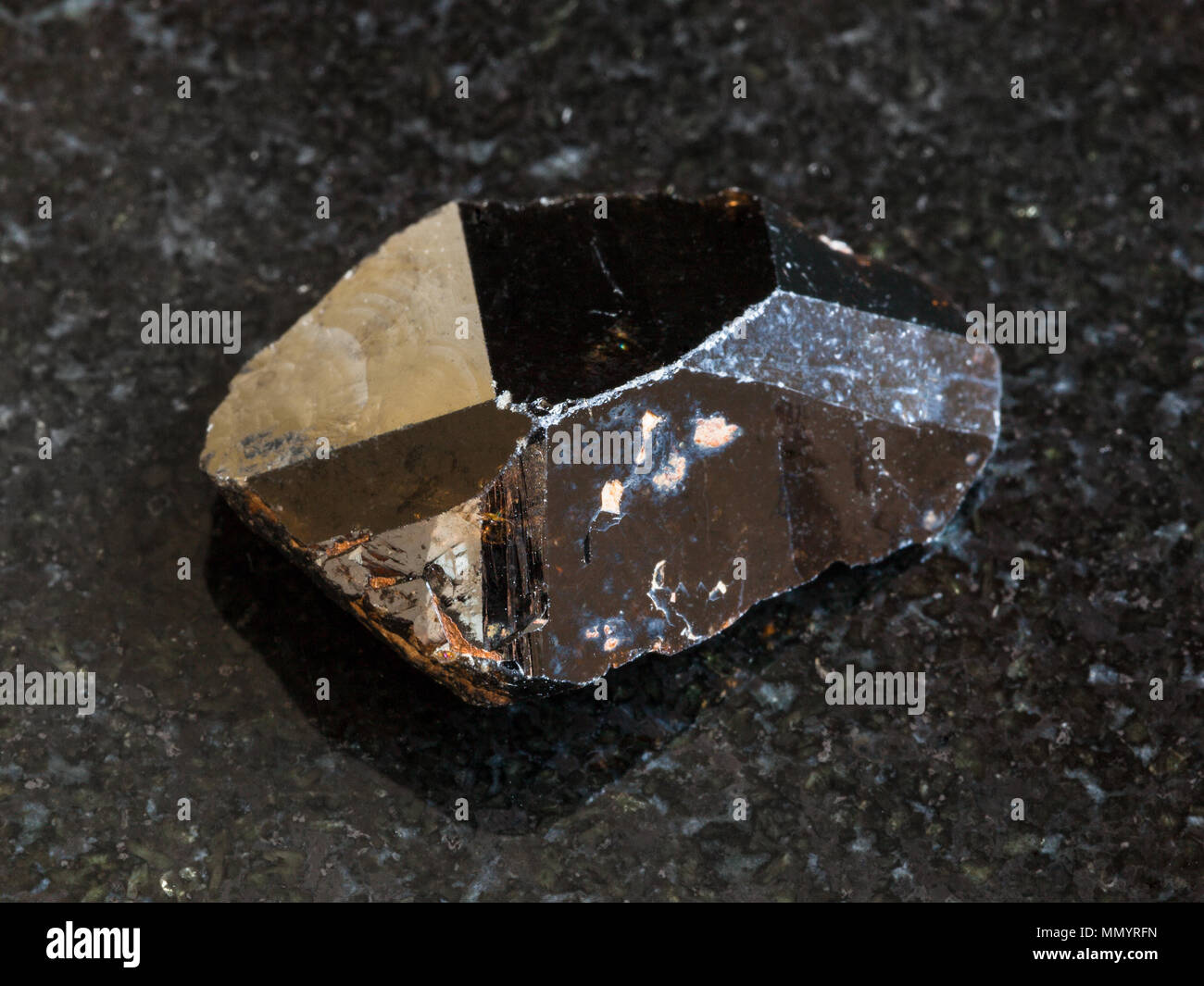 macro shooting of natural rock specimen - rough crystal of Cassiterite ...