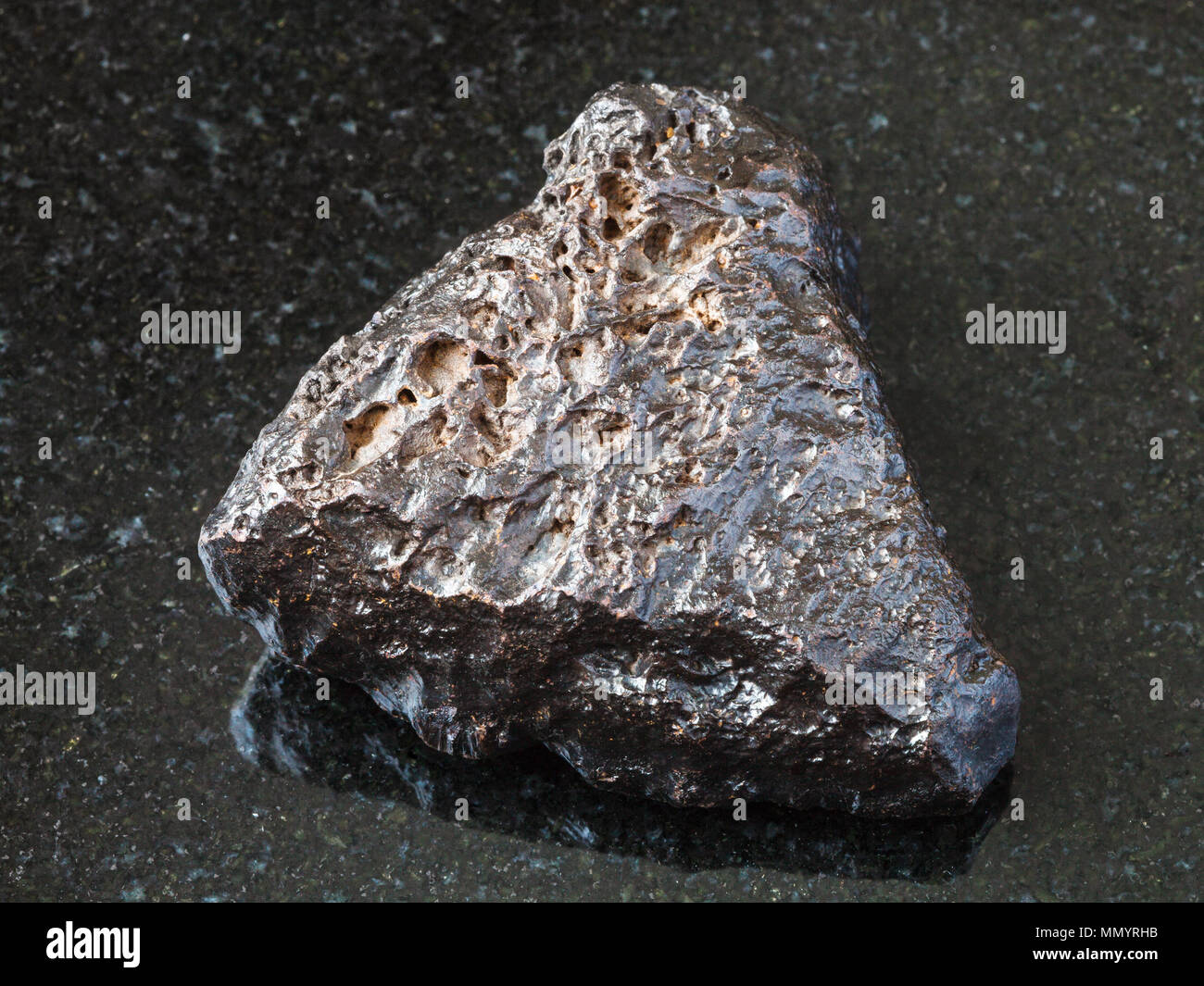 macro shooting of natural rock specimen - rough Hematite stone on black ...
