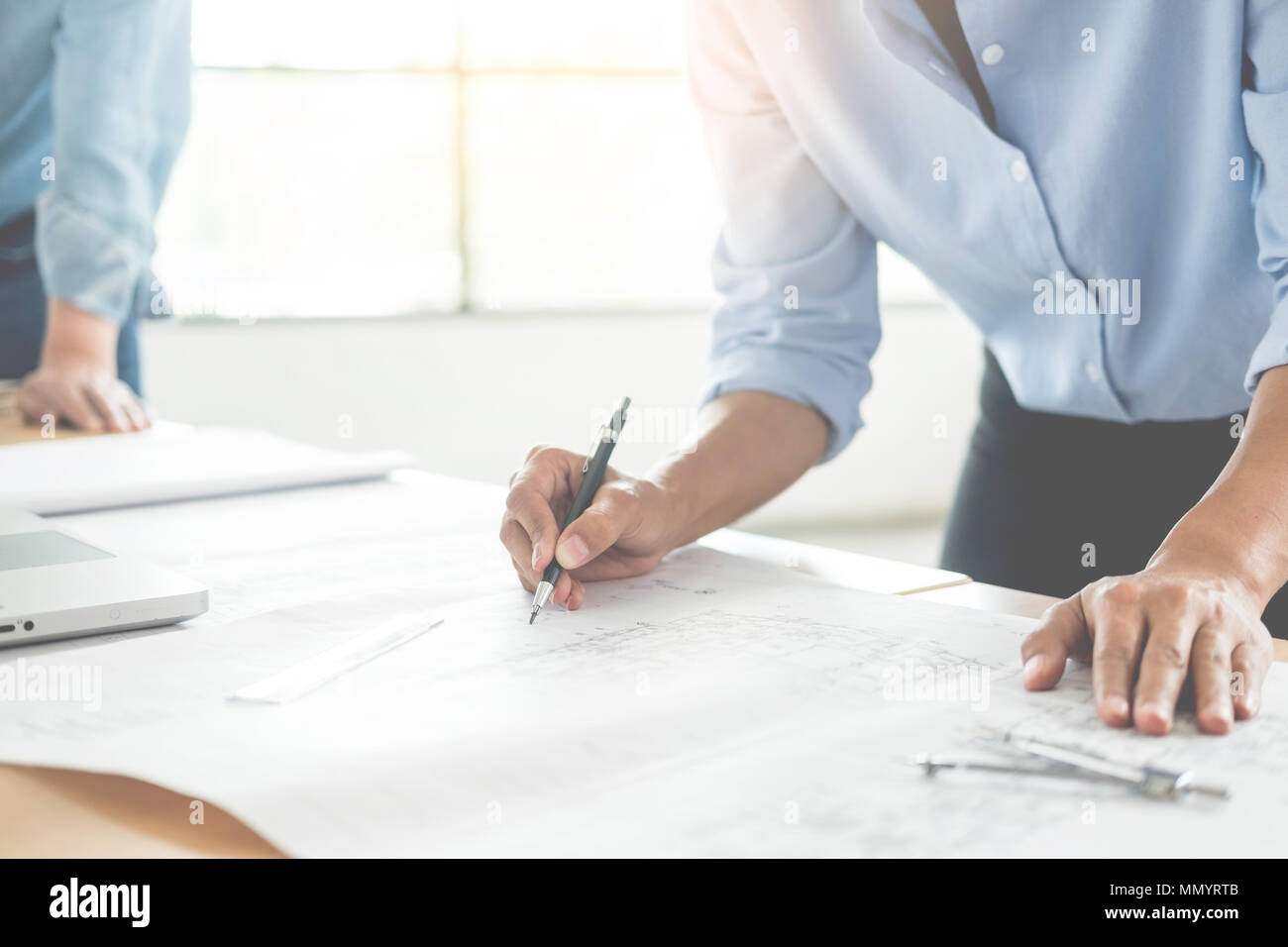 Close-up Of Person's engineer Hand Drawing Plan On Blue Print with ...