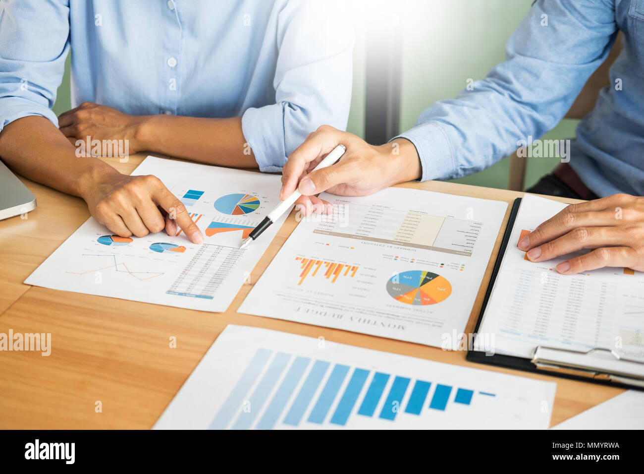 Business team hands at working with plan on office desk and modern ...