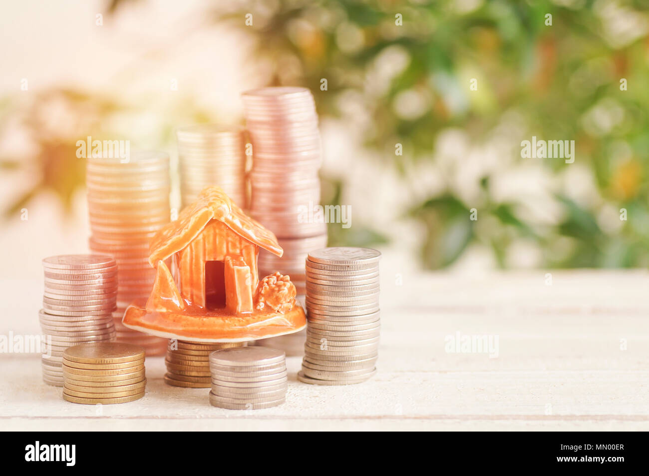 house on stacked of money coins, concept in growth, sell, buy, save and ...