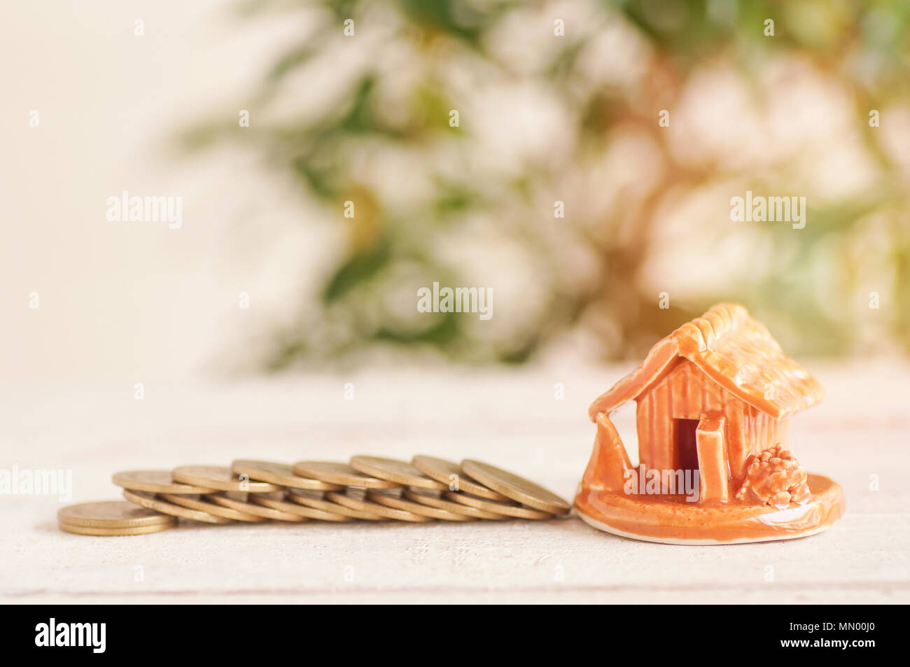 house and coins stacked on wood background, concept in growth, sell ...