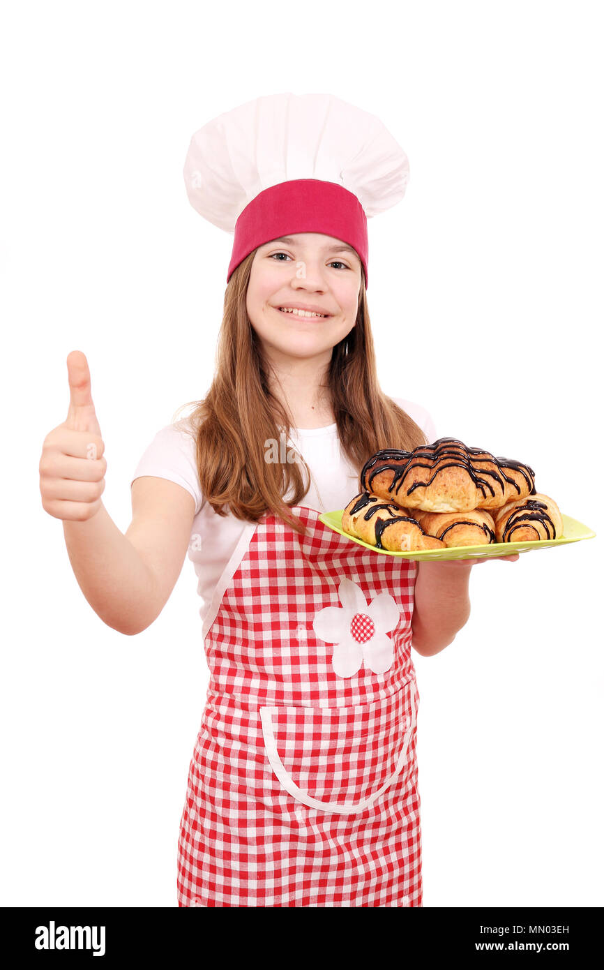 happy little girl cook with croissant and thumb up Stock Photo - Alamy