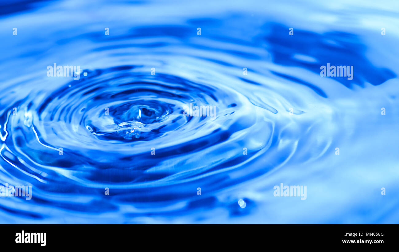 beautyful water drip in blue background Stock Photo - Alamy