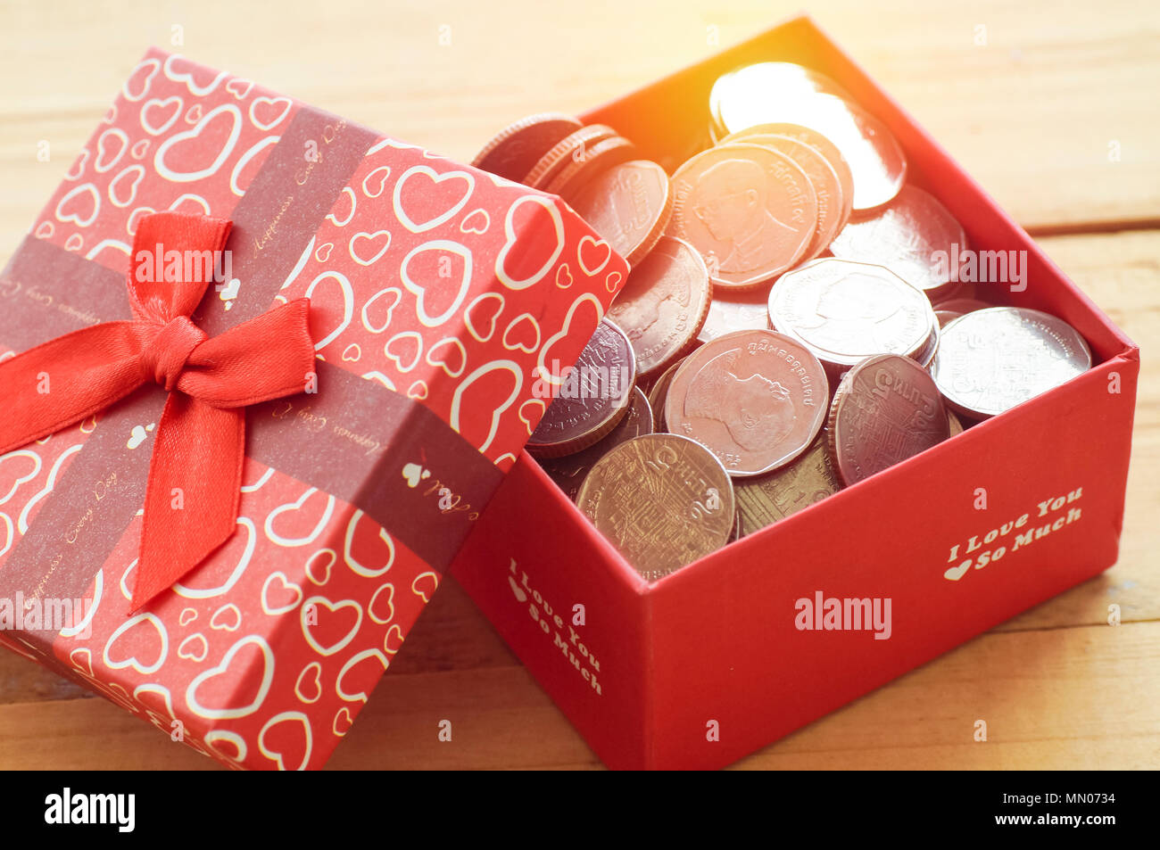 money coins in present and gift box on wood table Stock Photo - Alamy