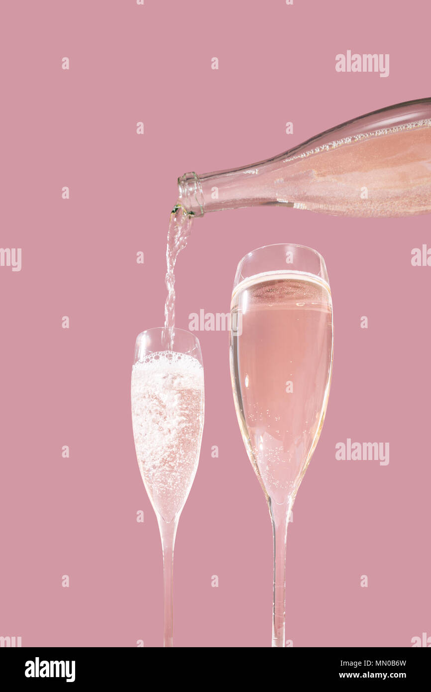 Valdobbiadene Prosecco flutes and a bottle, pink background, in pop ...