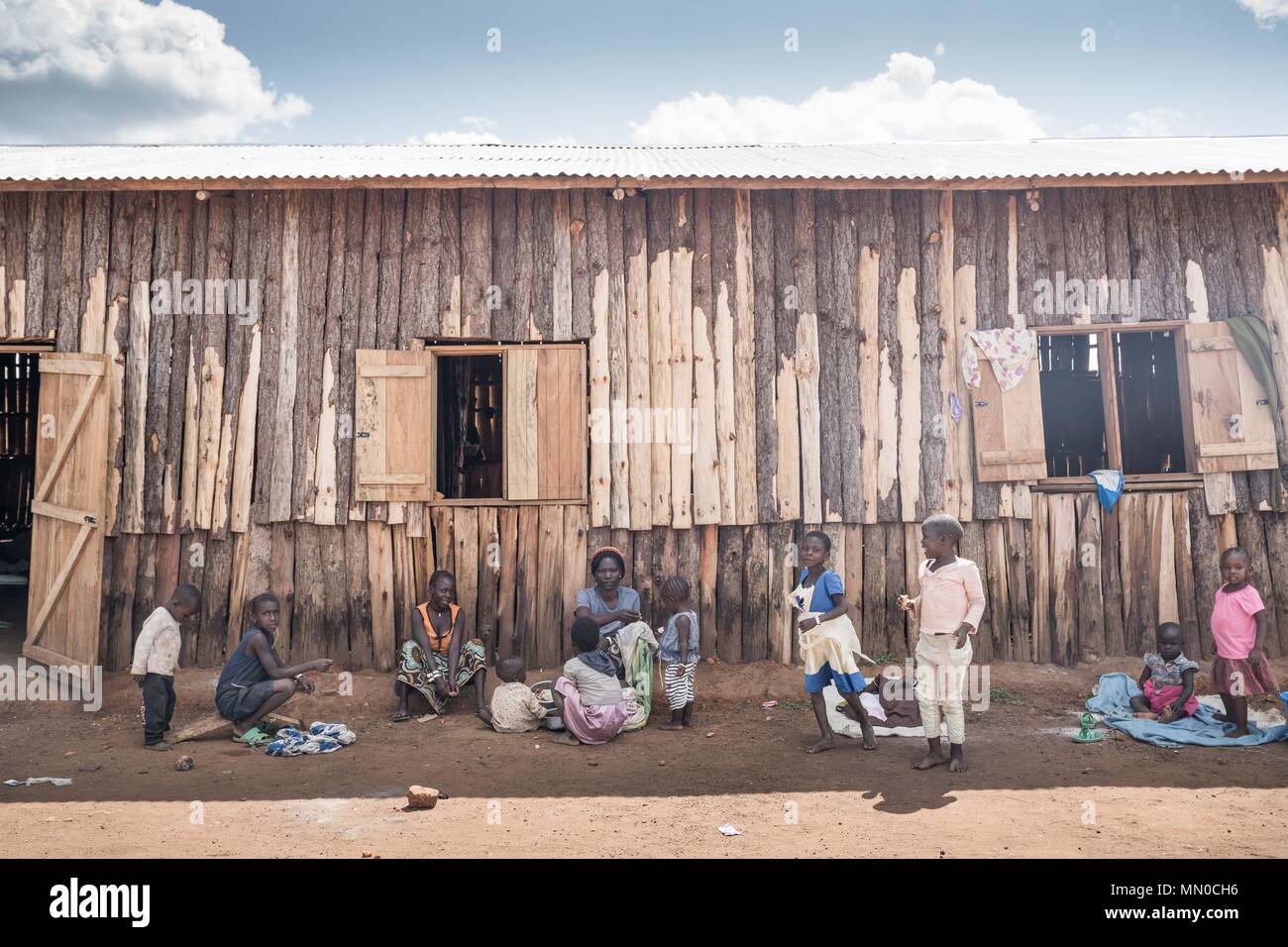 Congolese refugees seen spending their day outside their temporary ...
