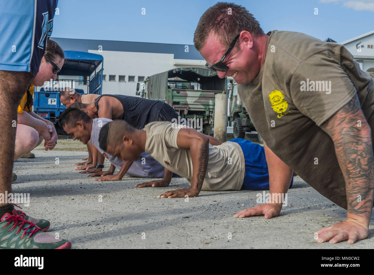 U.S. Navy Sailors and Timor-Leste service members do pushups during ...