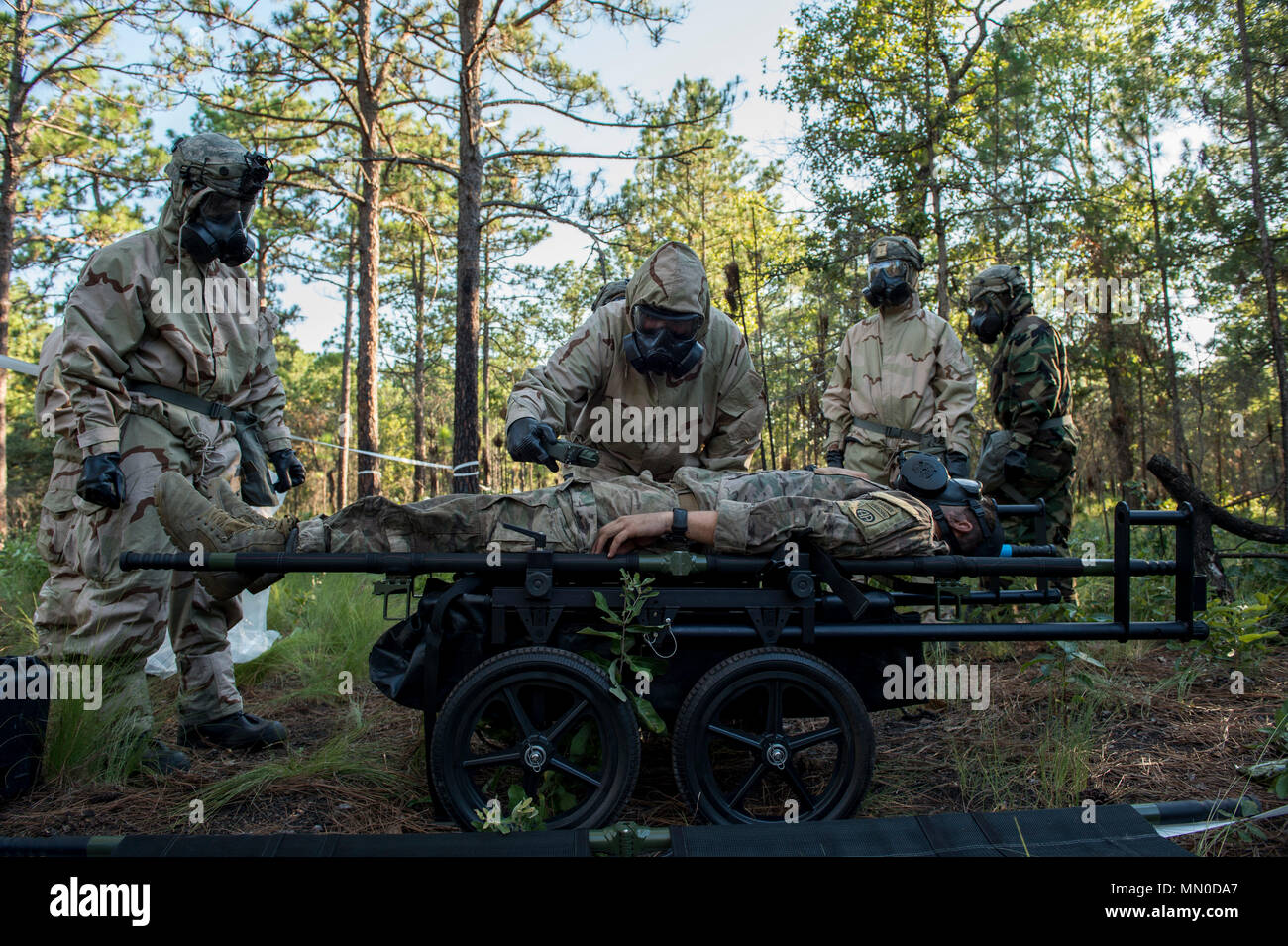 A U.S. Army decontamination team member uses an instrument to scan for ...