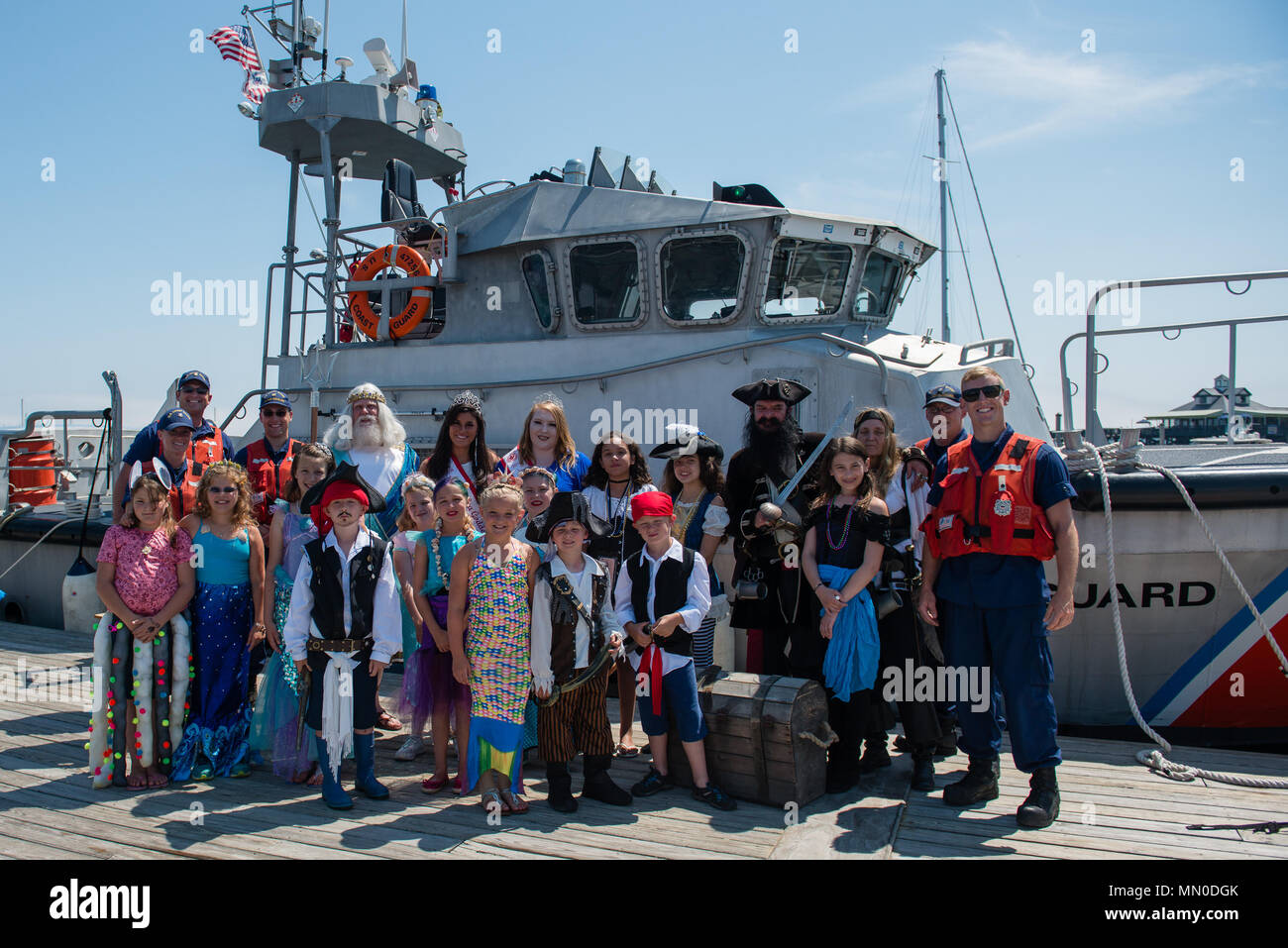 A Coast Guard 47-foot Motor Lifeboat crew poses with King Neptune and ...