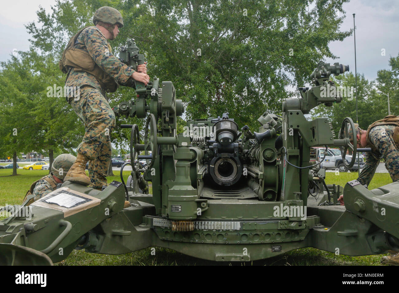 Marines make adjustments to the M777 Light Towed Howitzer during a ...