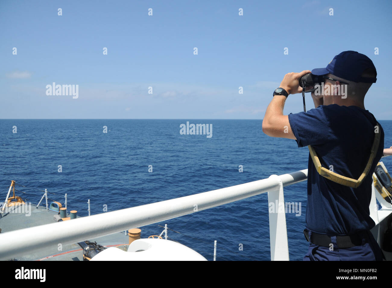 Coast Guard Seaman Timmy Young stands watch on the Coast Guard Cutter ...