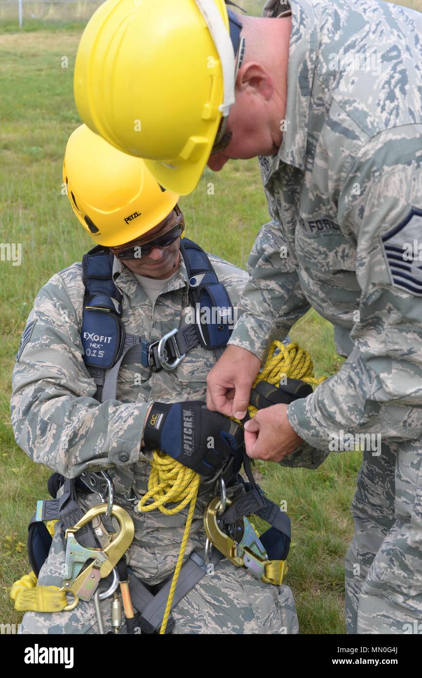 U.S. Air Force Master Sgt. Brett Bickford assists Staff Sgt. David ...