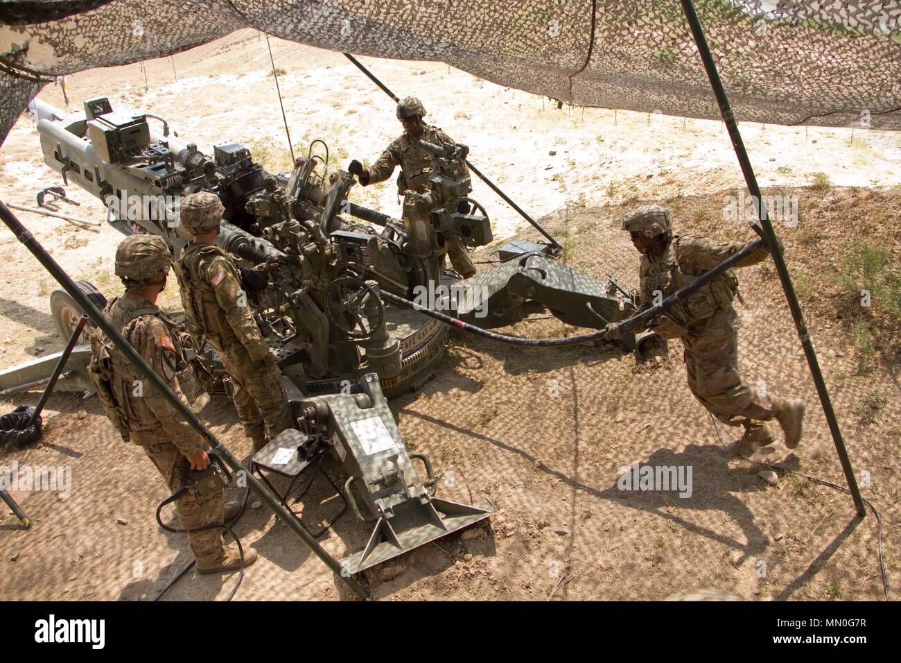 Spc. Avery Lebron Johnson Jr. (R), a cannon crewmember in 1st Platoon ...