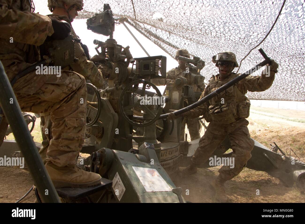 Spc. Avery Lebron Johnson Jr. (R), a cannon crewmember in 1st Platoon ...