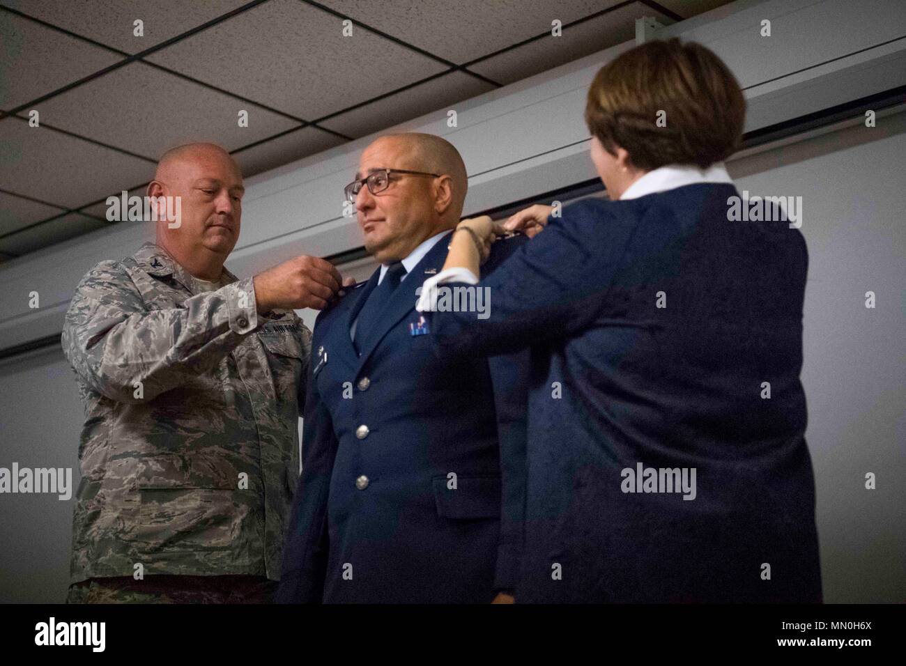 Col. Johnny Ryan, commander of the 130th Airlift Wing, administers the ...