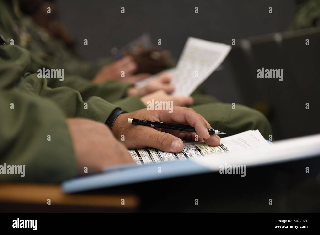 U.S. Air Force members of the 156th Airlift Squadron take notes during ...