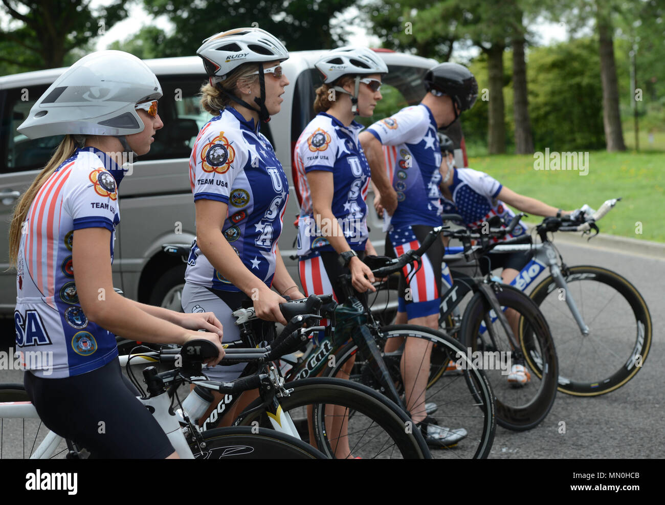 U.S. Armed Forces Triathlon team members gather for a bicycle ride ...