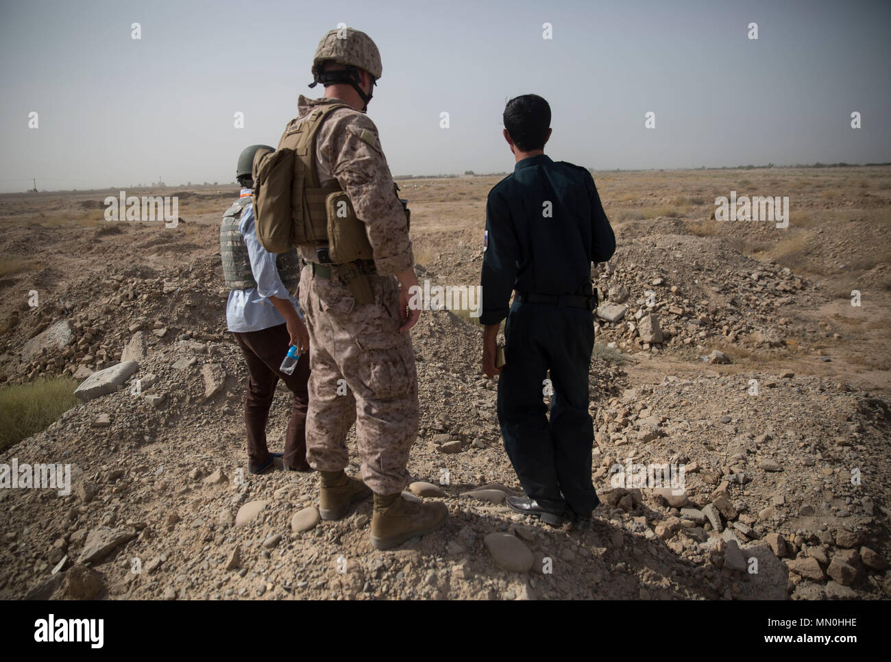 A U.S. Marine advisor with Task Force Southwest surveys a site for an ...